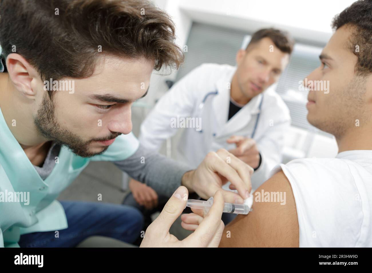 young doctor making patient injection Stock Photo - Alamy