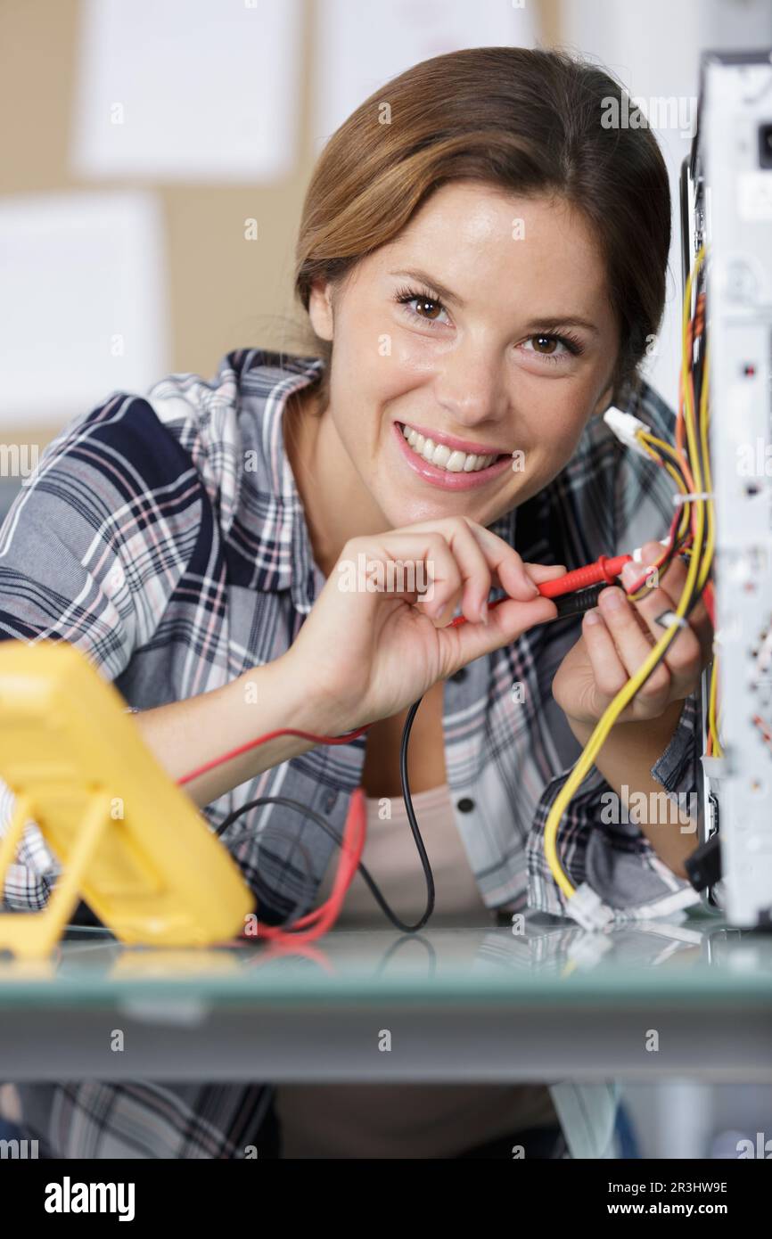young woman testing electric tension on computer Stock Photo - Alamy