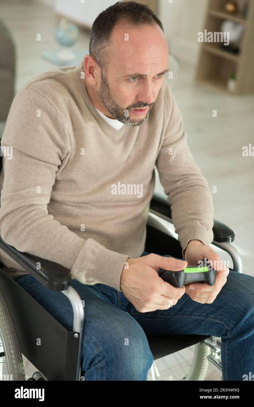 Disabled man playing video game hi-res stock photography and images - Alamy