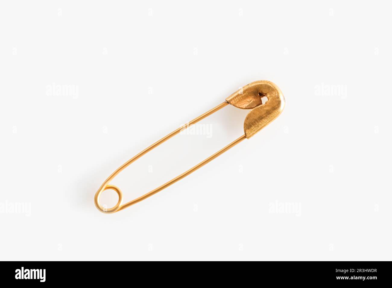 Golden safety pin on white background, top view Stock Photo - Alamy