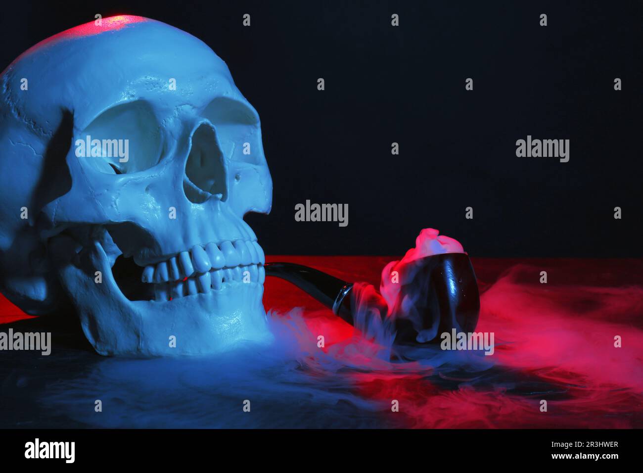 Human skull with pipe and smoke in neon lights on black background ...