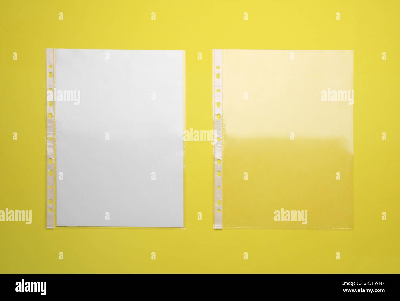 Punched pockets on yellow background, flat lay Stock Photo - Alamy
