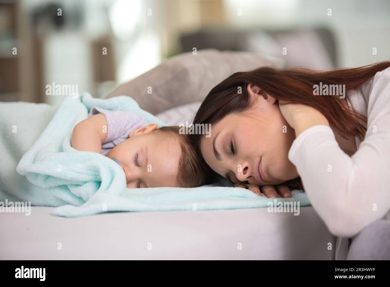 Tired mother newborn asleep together hi-res stock photography and ...