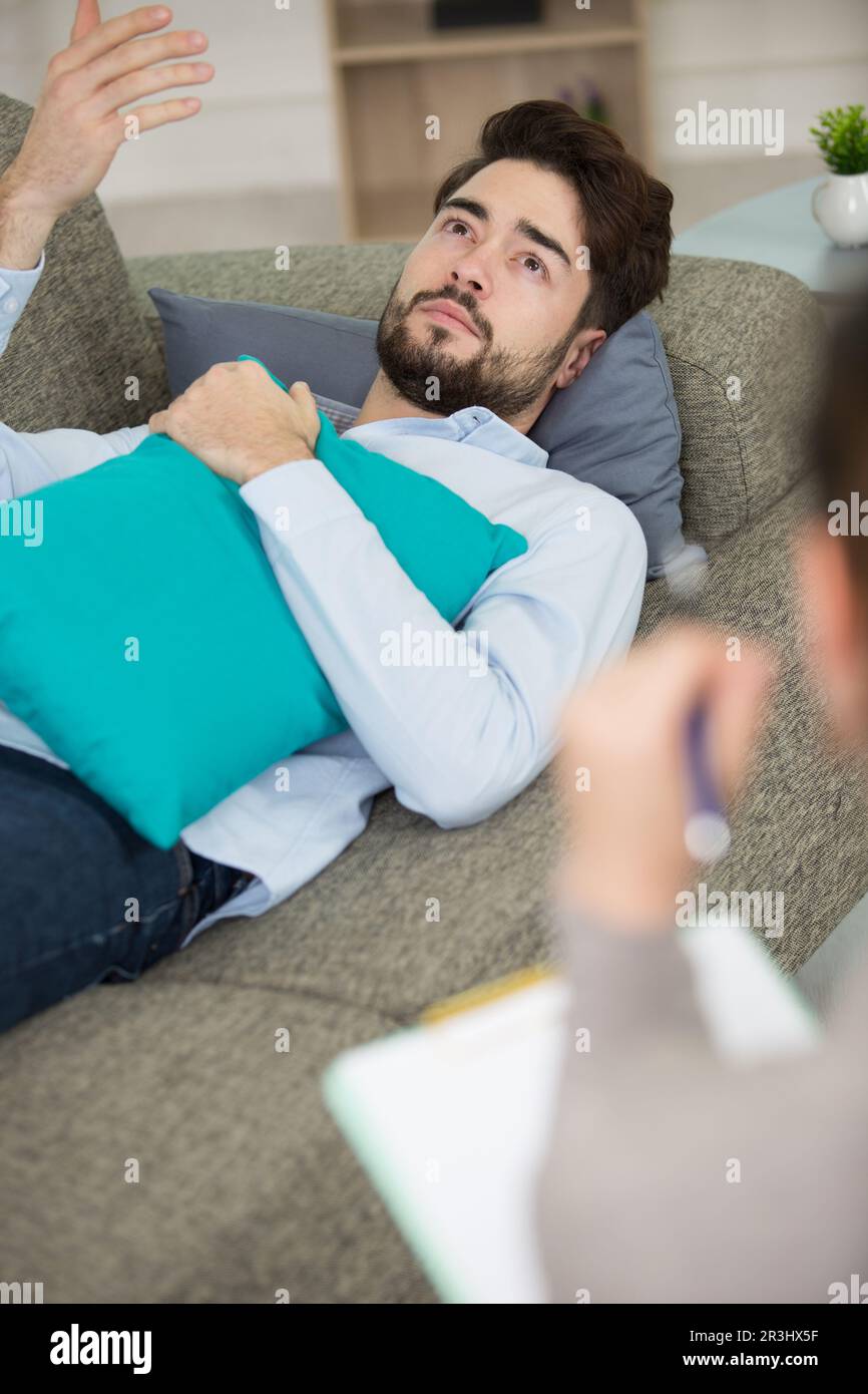 sad man explaining therapist a problem Stock Photo - Alamy