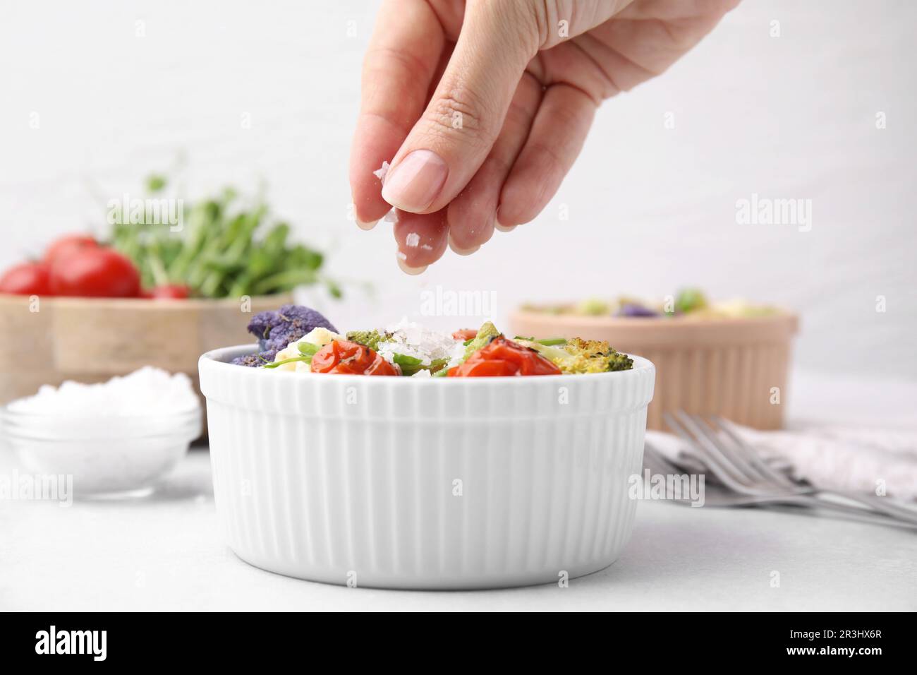 Woman salting delicious salad hi-res stock photography and images - Alamy