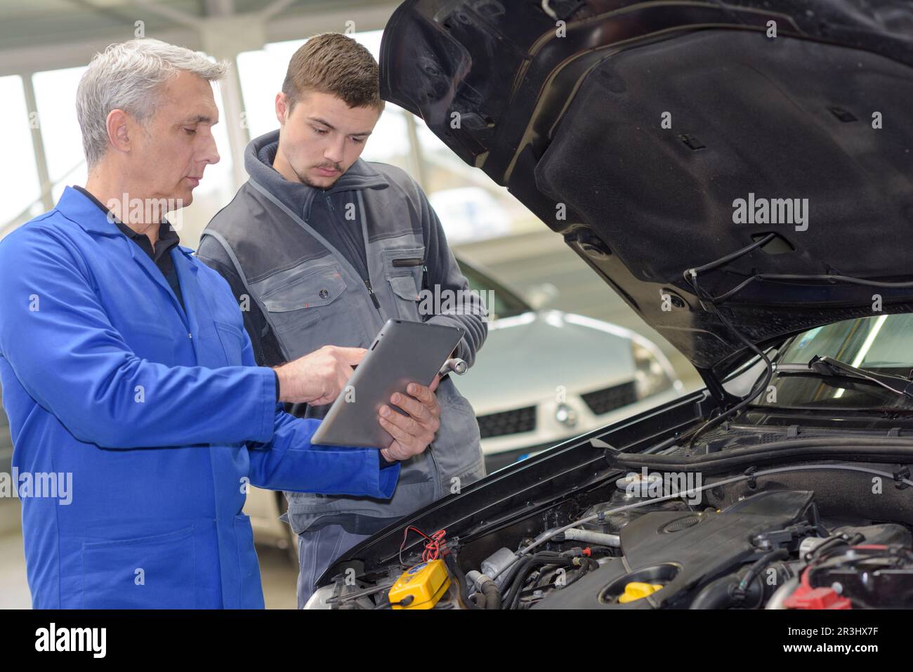 student with instructor repairing a car during apprenticeship Stock ...