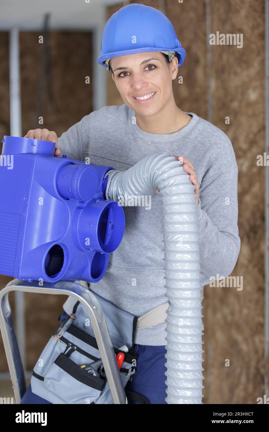 women in the male profession a girl repairs an ac Stock Photo - Alamy