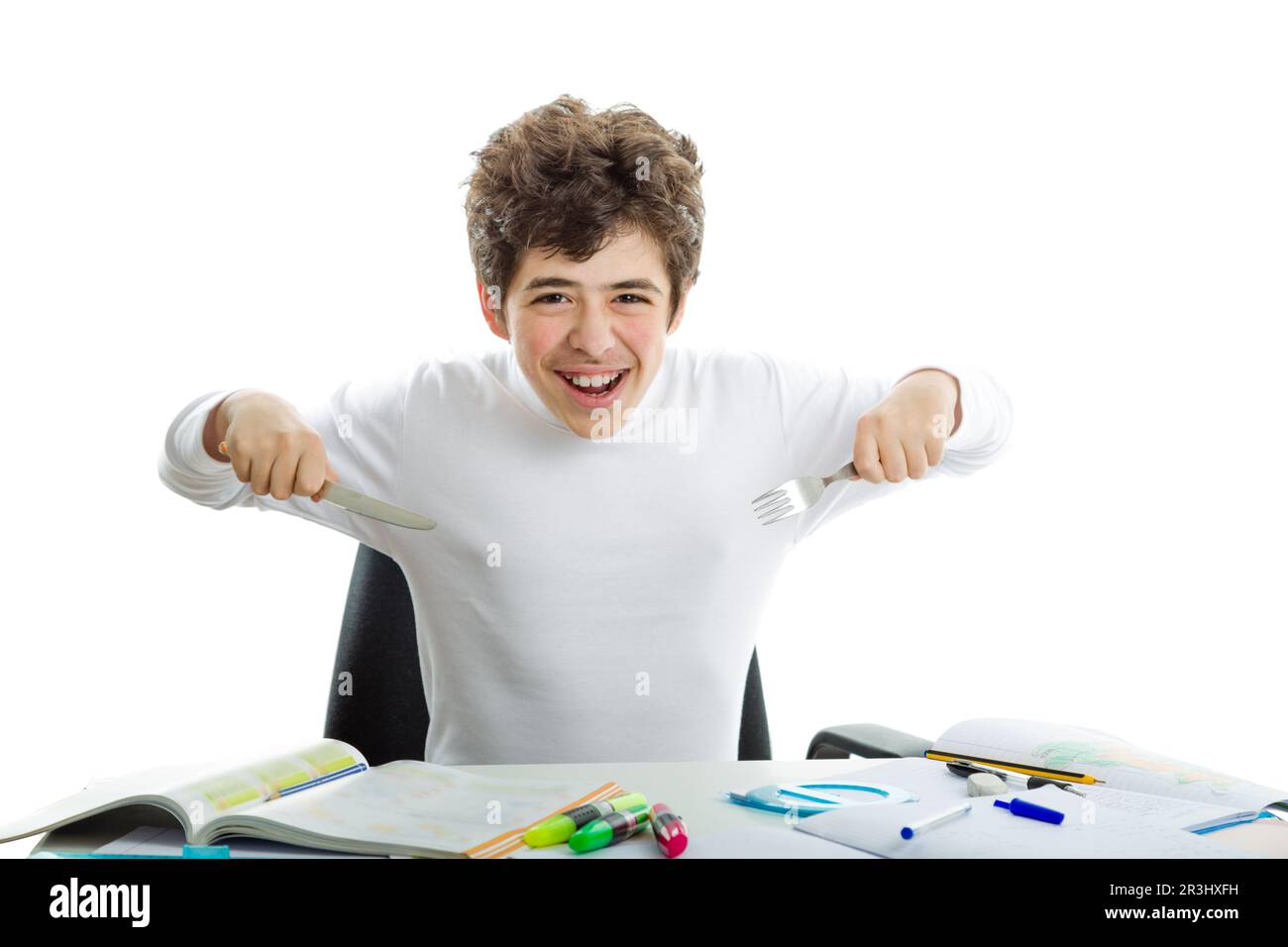 Boy doing homework with fork and knife Stock Photo - Alamy