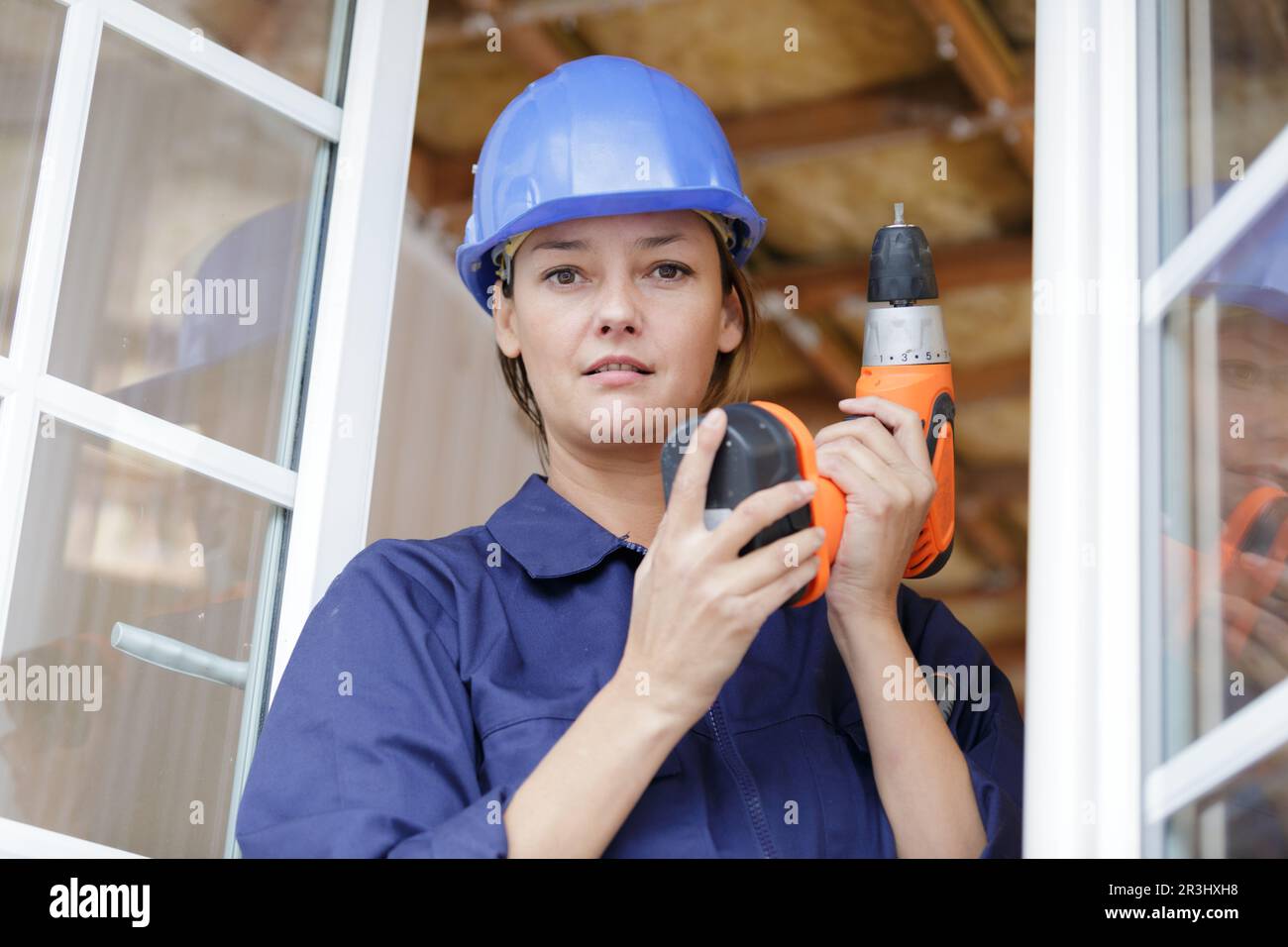 woman with toolbelt using drill Stock Photo - Alamy