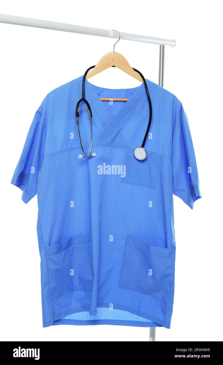 Light blue medical uniform and stethoscope on rack against white ...
