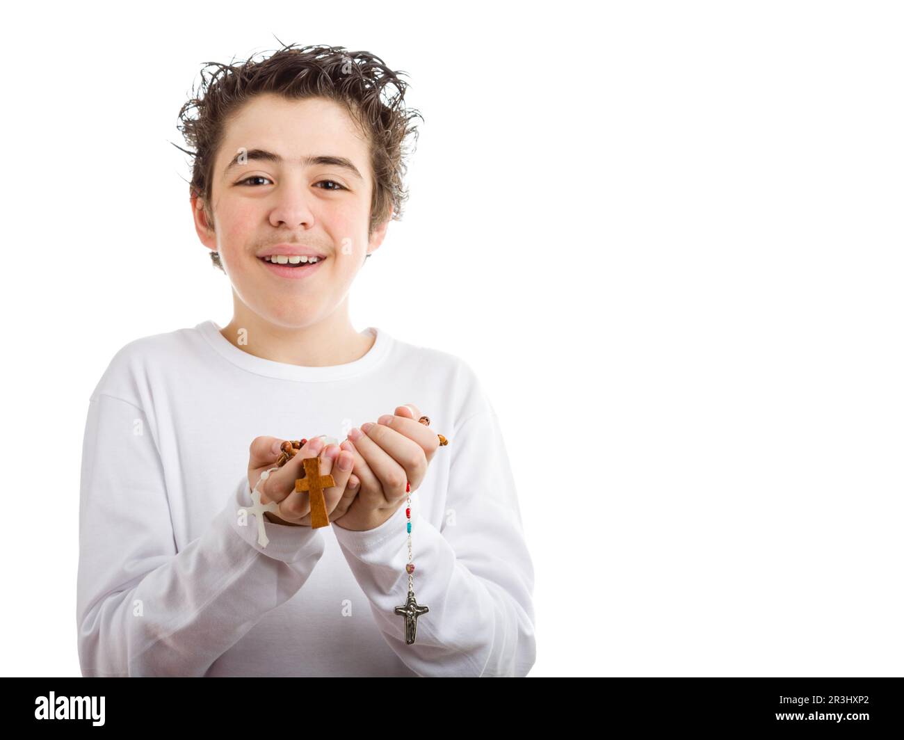 Caucasian boy holding rosary beads Stock Photo - Alamy