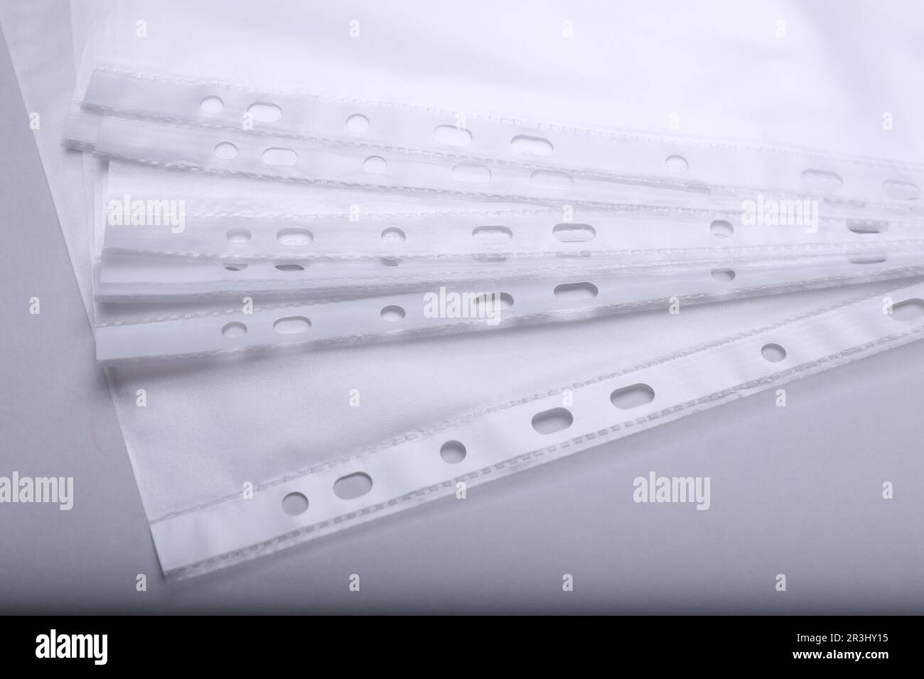 Many punched pockets on light grey background, closeup Stock Photo - Alamy