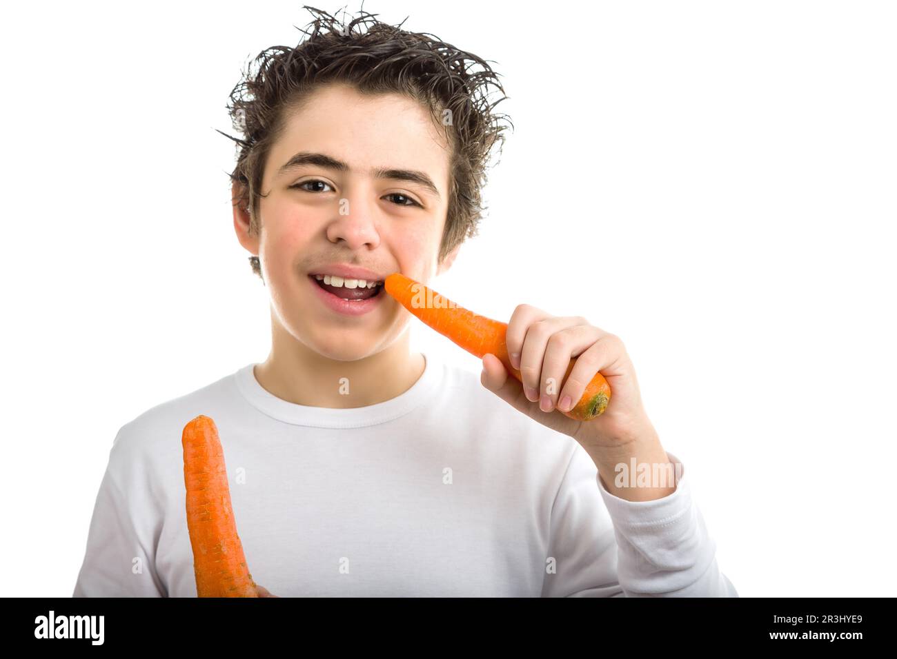 Caucasian smooth-skinned boy eating organic carrot Stock Photo - Alamy