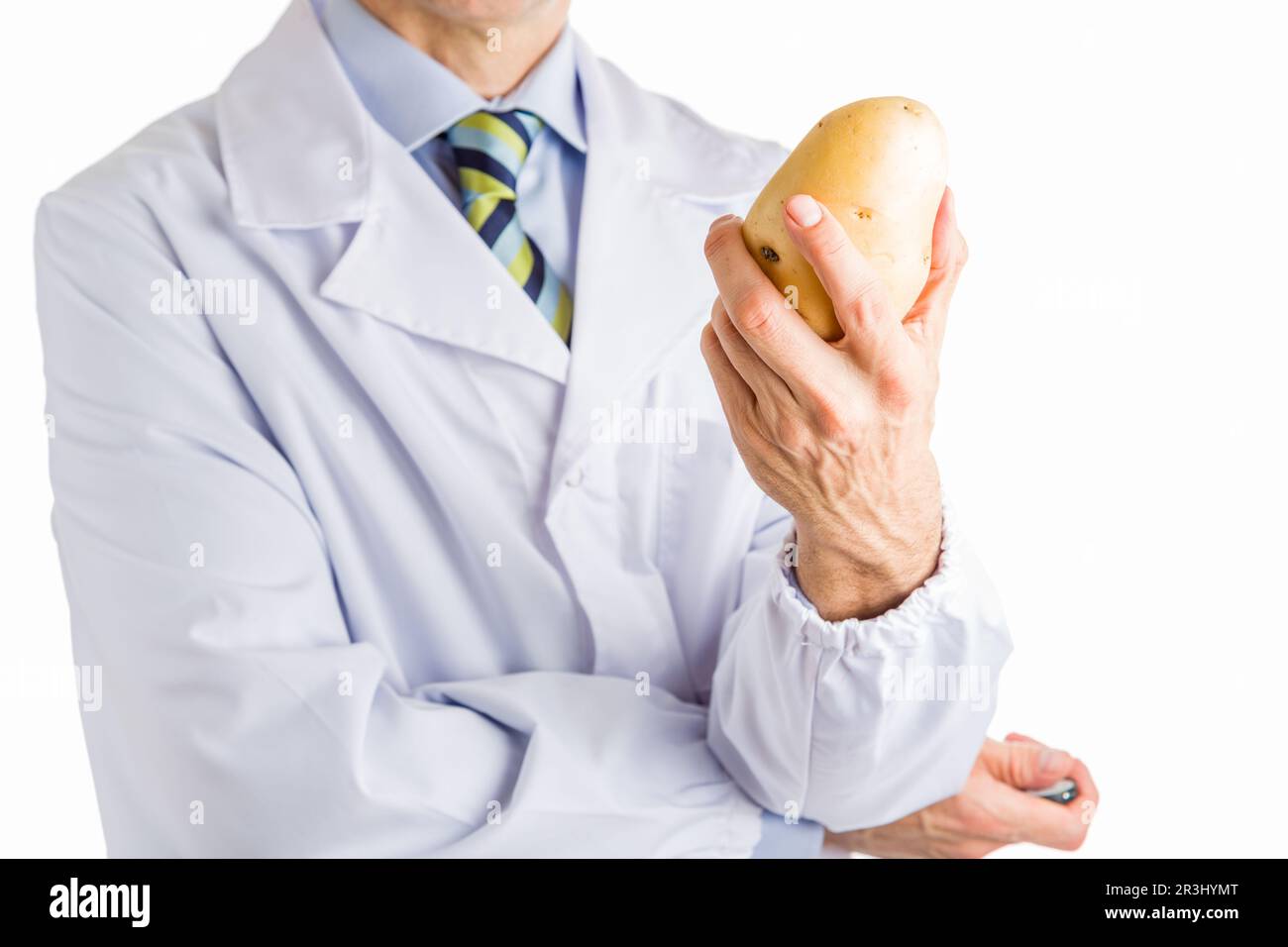 Man in medical white coat showing potato Stock Photo - Alamy
