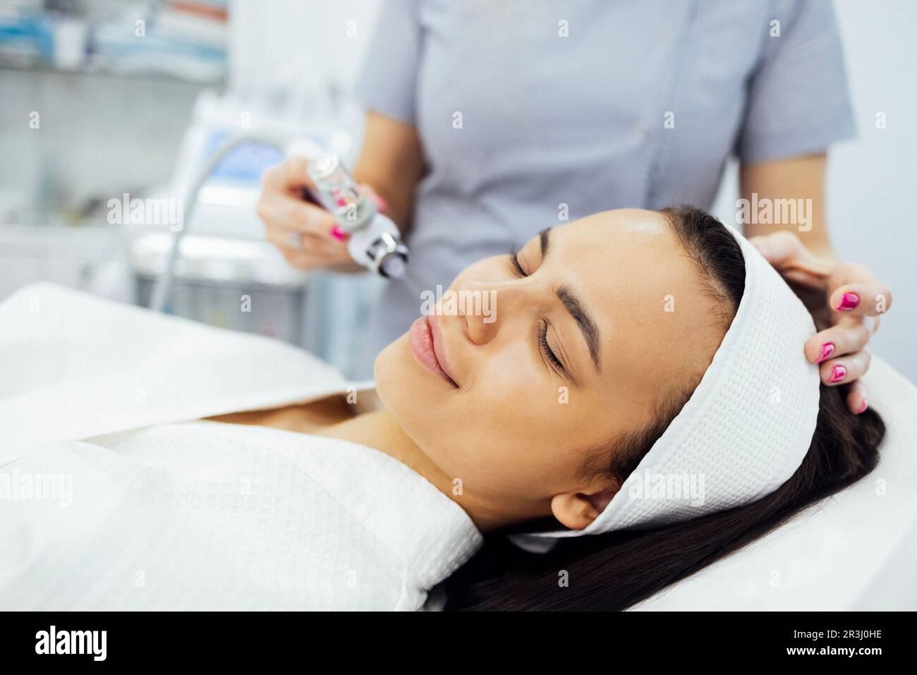 Caucasian woman getting face peeling procedure in a beauty clinic ...