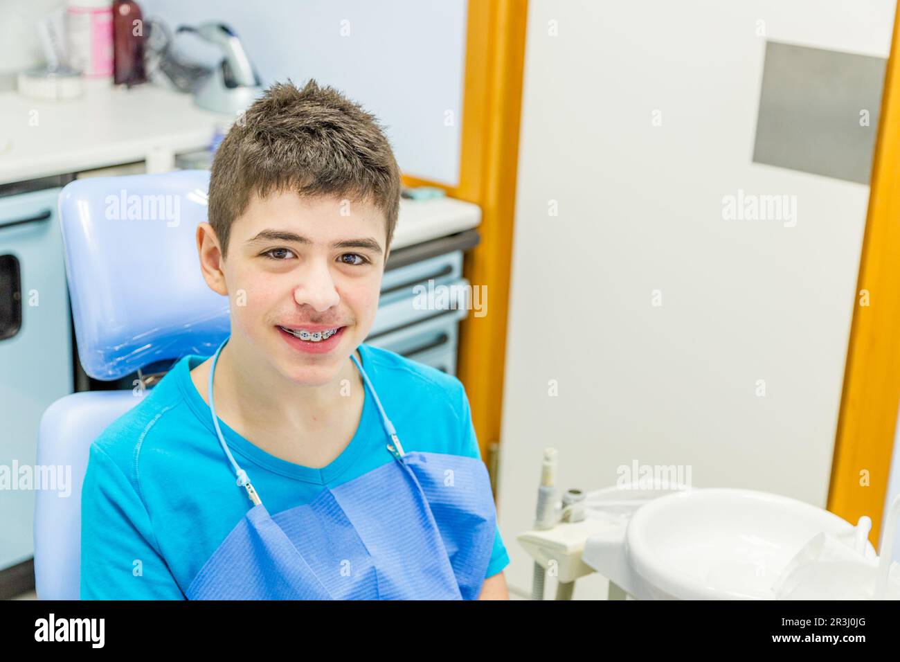 Boy with braces in the chair of the dentist Stock Photo - Alamy