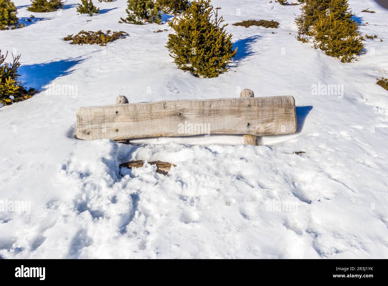 Wooden bench buried in snow Stock Photo - Alamy