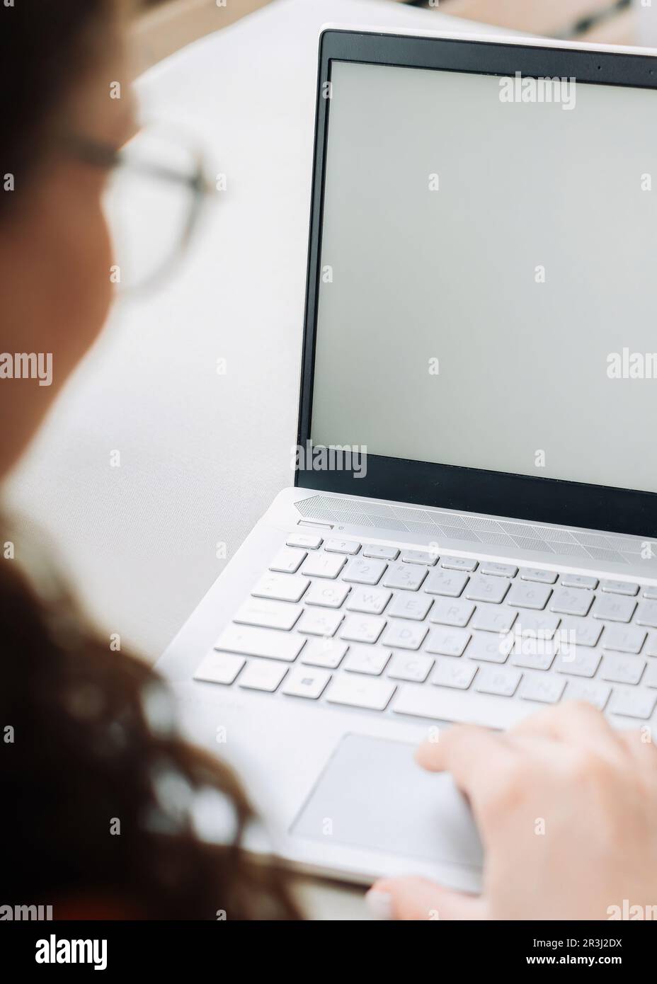 Over shoulder view of woman student elearning looking at white mock up ...