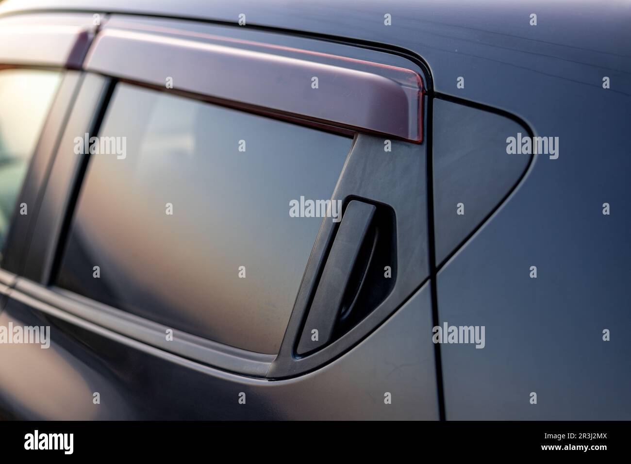 Vertical door handle of a vehicle closeup Stock Photo - Alamy