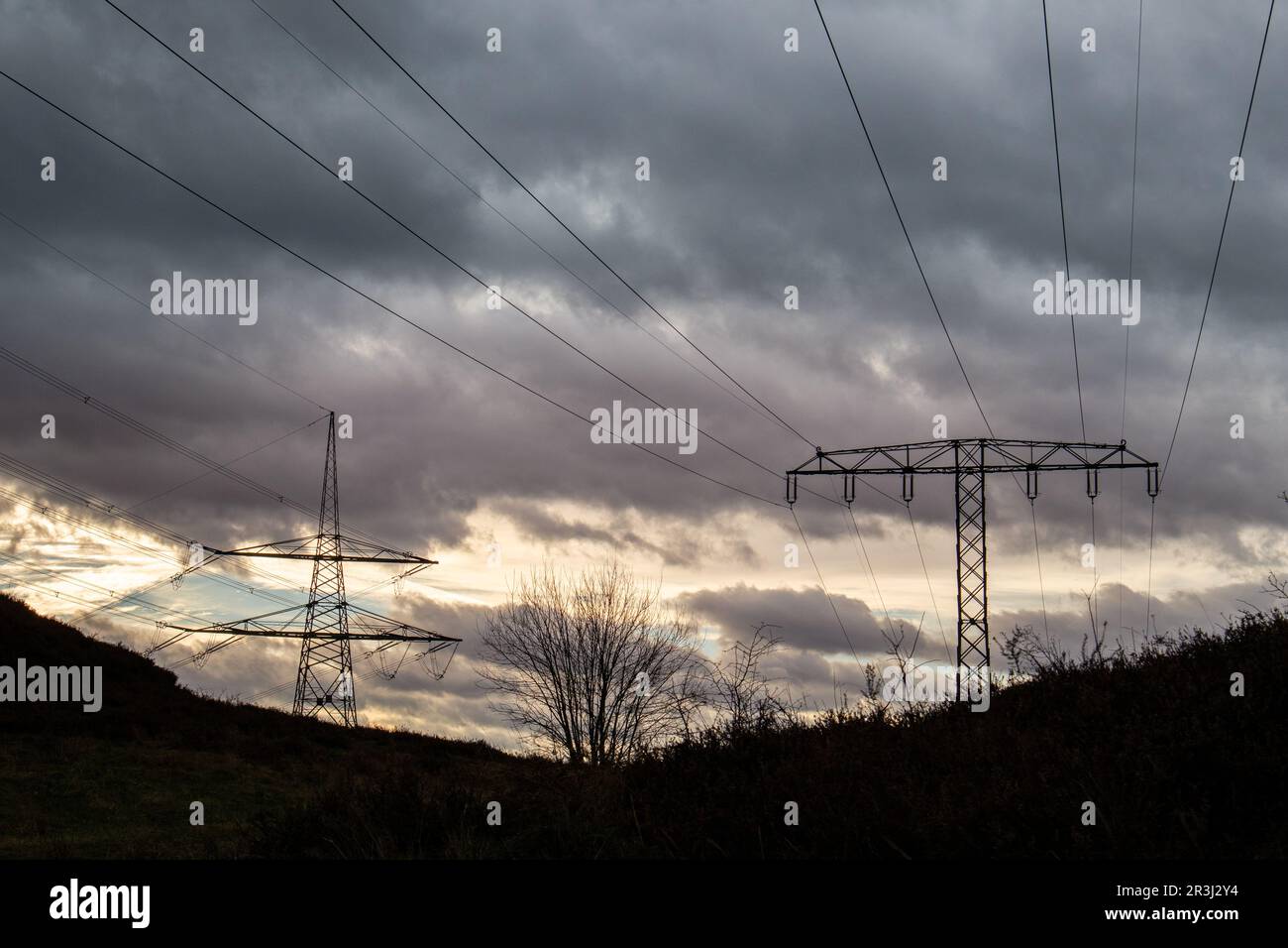 High voltage power line overhead line sunset Stock Photo - Alamy