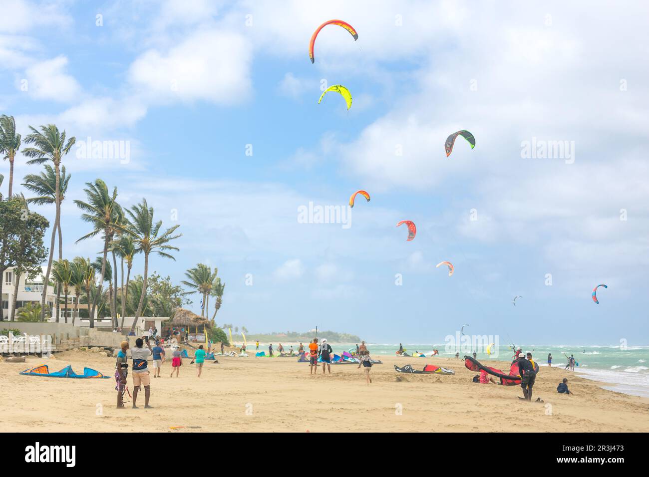 Crowd of active sporty people enjoying kitesurfing holidays and ...