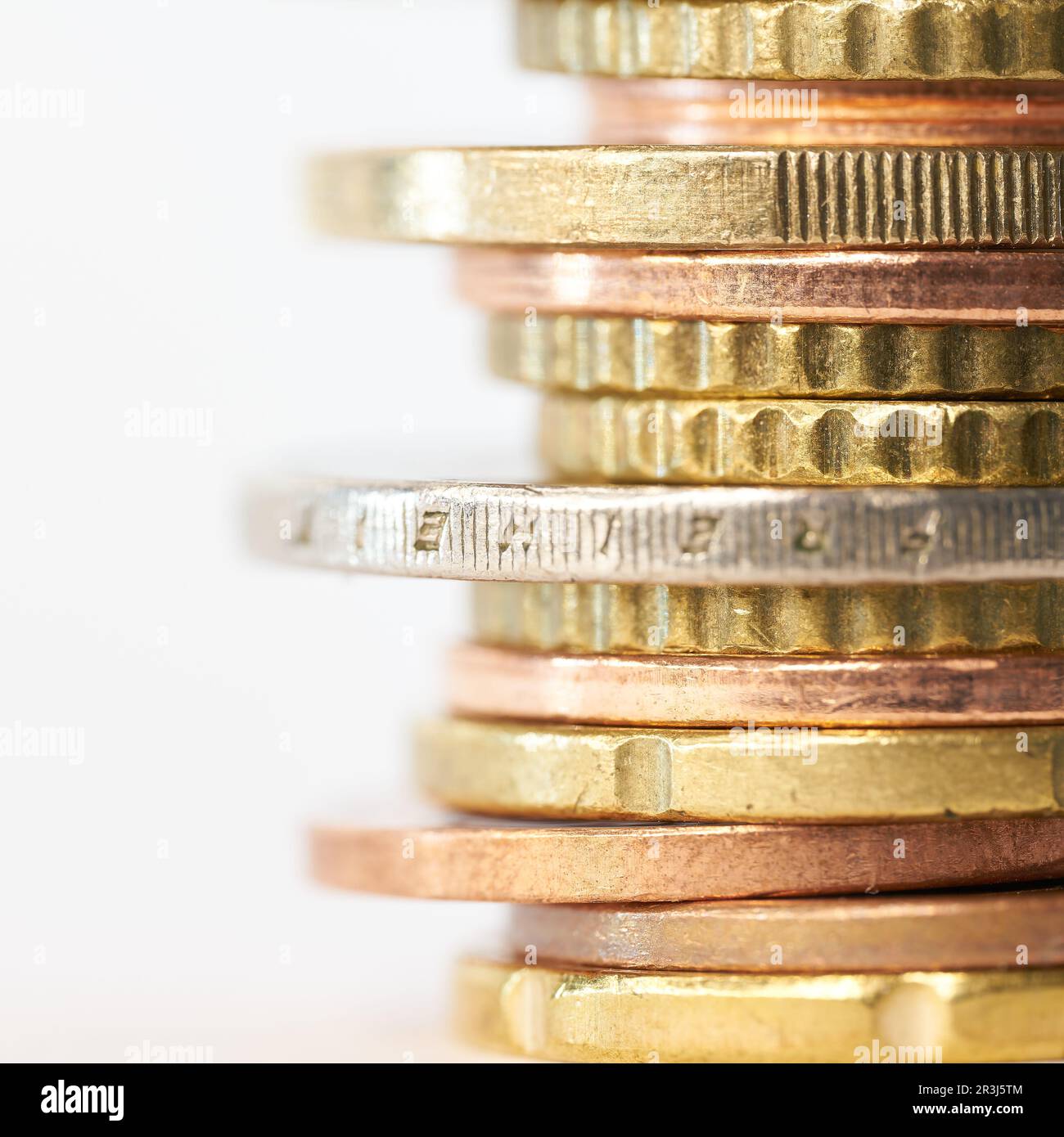 Piled up euro coins on table with white background Stock Photo - Alamy