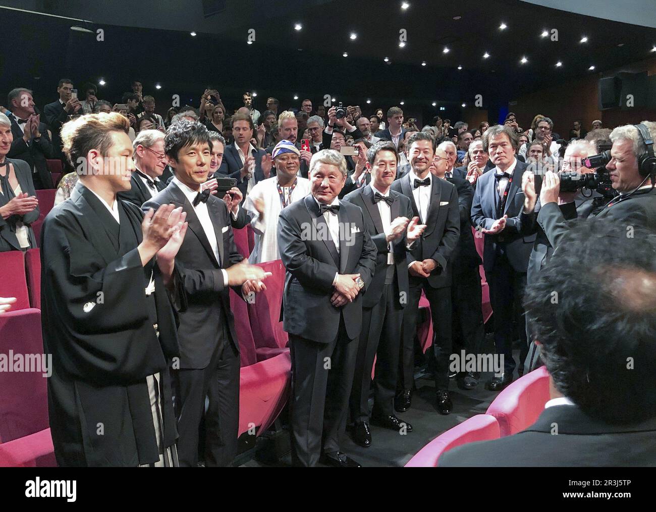 Japanese film director Takeshi Kitano (3rd from L) and cast members ...