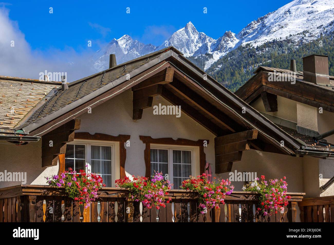 Swiss Alps in Switzerland, house wooden balcony decorated with flowers ...