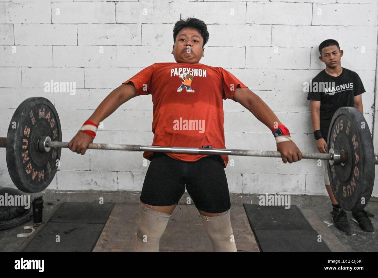 Bogor, Indonesia. 23rd May, 2023. A boy practices weightlifting at ...
