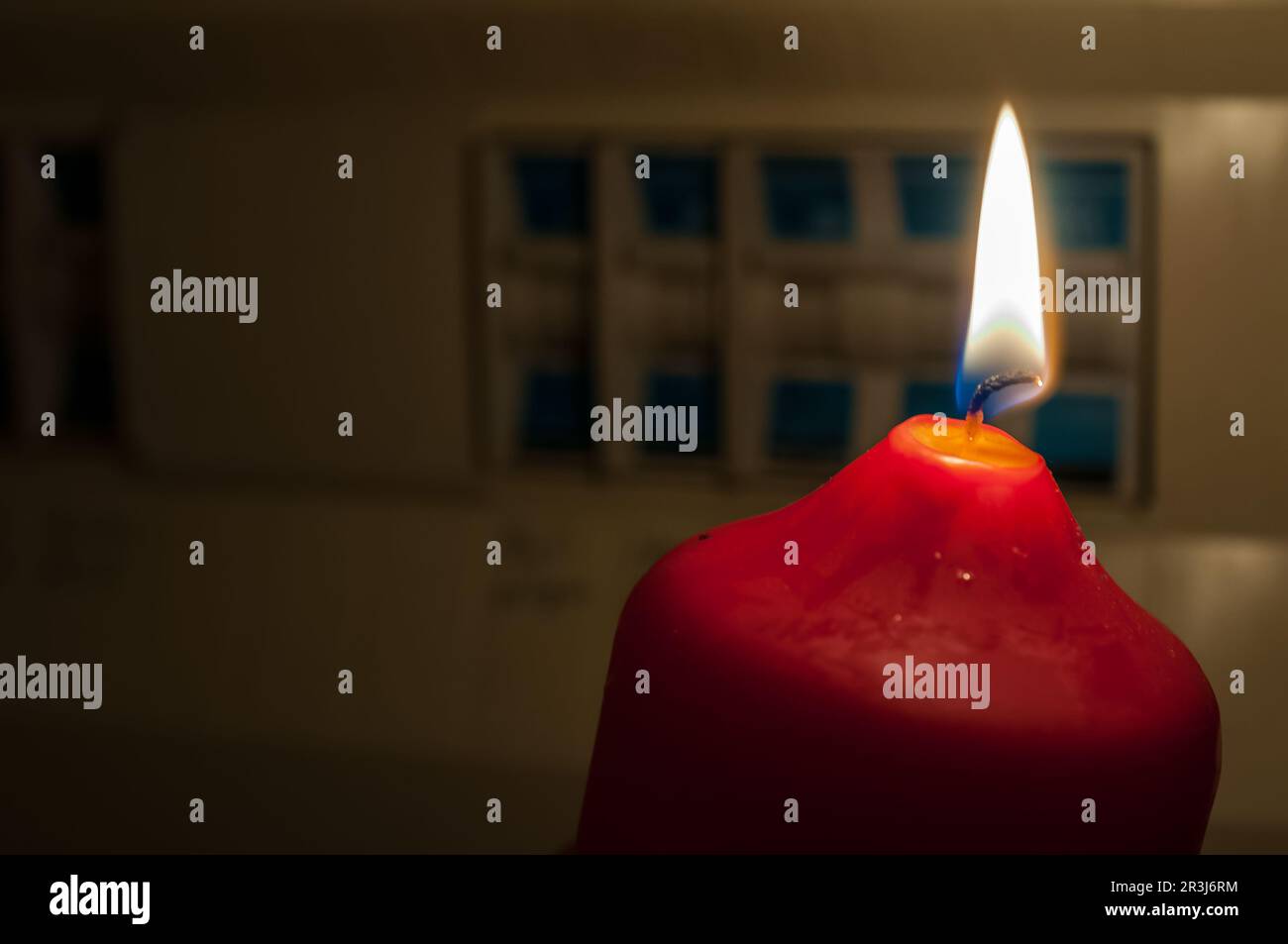 Red candle and electrical switches, electricity cut-off Stock Photo - Alamy