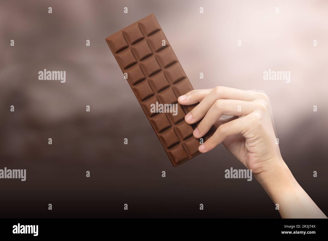 Human hand holding the chocolate bar. World chocolate day concept Stock ...