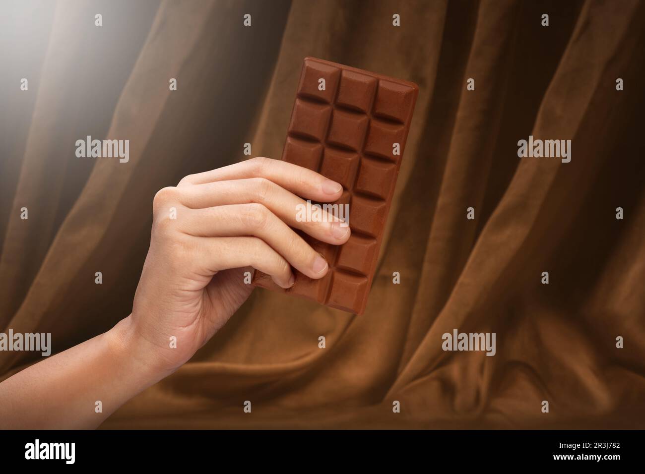 Human hand holding the chocolate bar. World chocolate day concept Stock ...