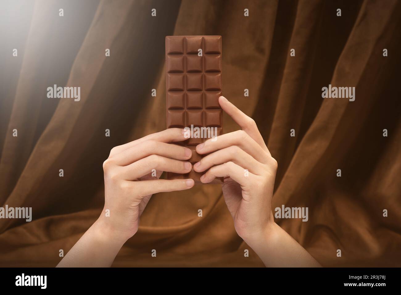 Human hand holding the chocolate bar. World chocolate day concept Stock ...