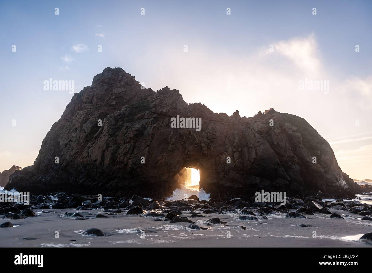 Wide-angle shot of the keyhole arch at Pfeiffer beach, California, whit ...