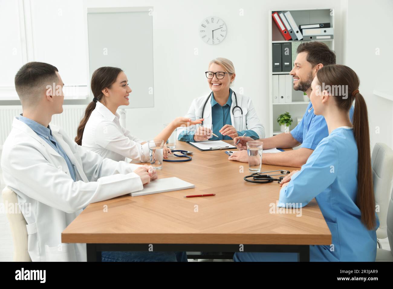 Medical conference. Team of doctors having discussion with speaker at ...