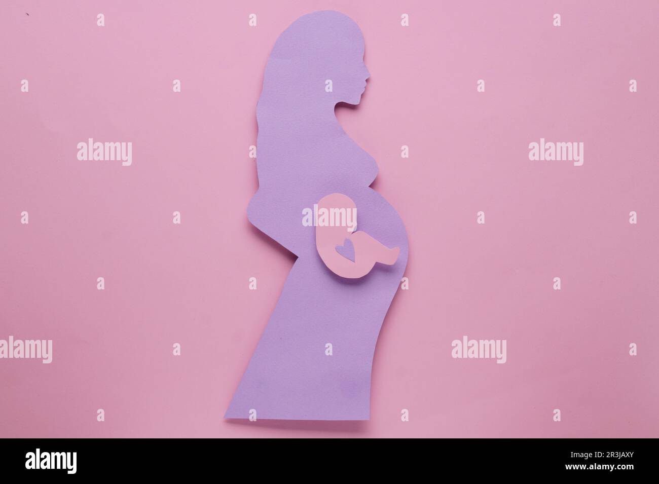 Woman`s health. Pregnant woman with baby on pale pink background, top ...