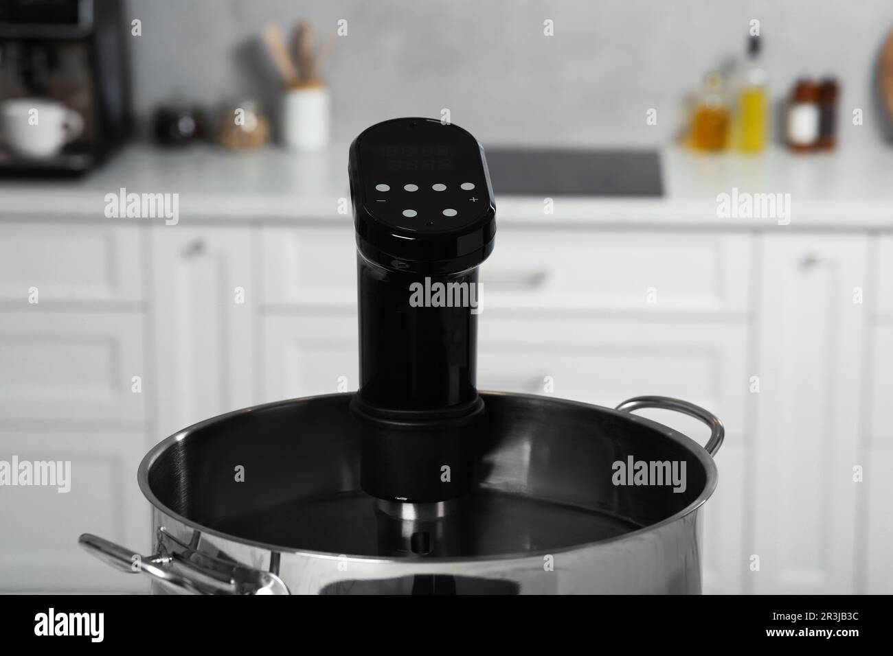 Pot with sous vide cooker in kitchen, closeup. Thermal immersion ...