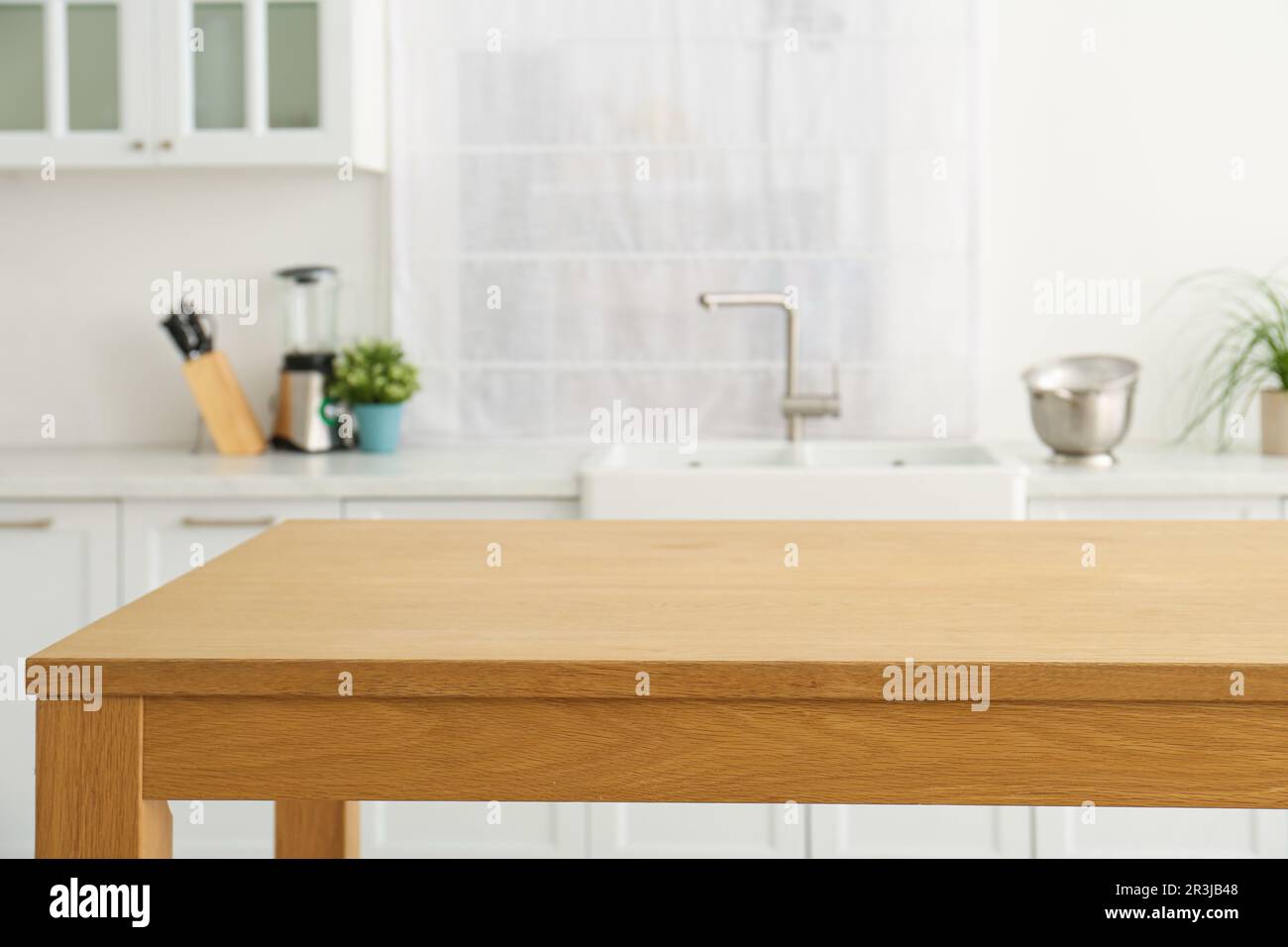 Stylish wooden table in kitchen. Interior design Stock Photo - Alamy