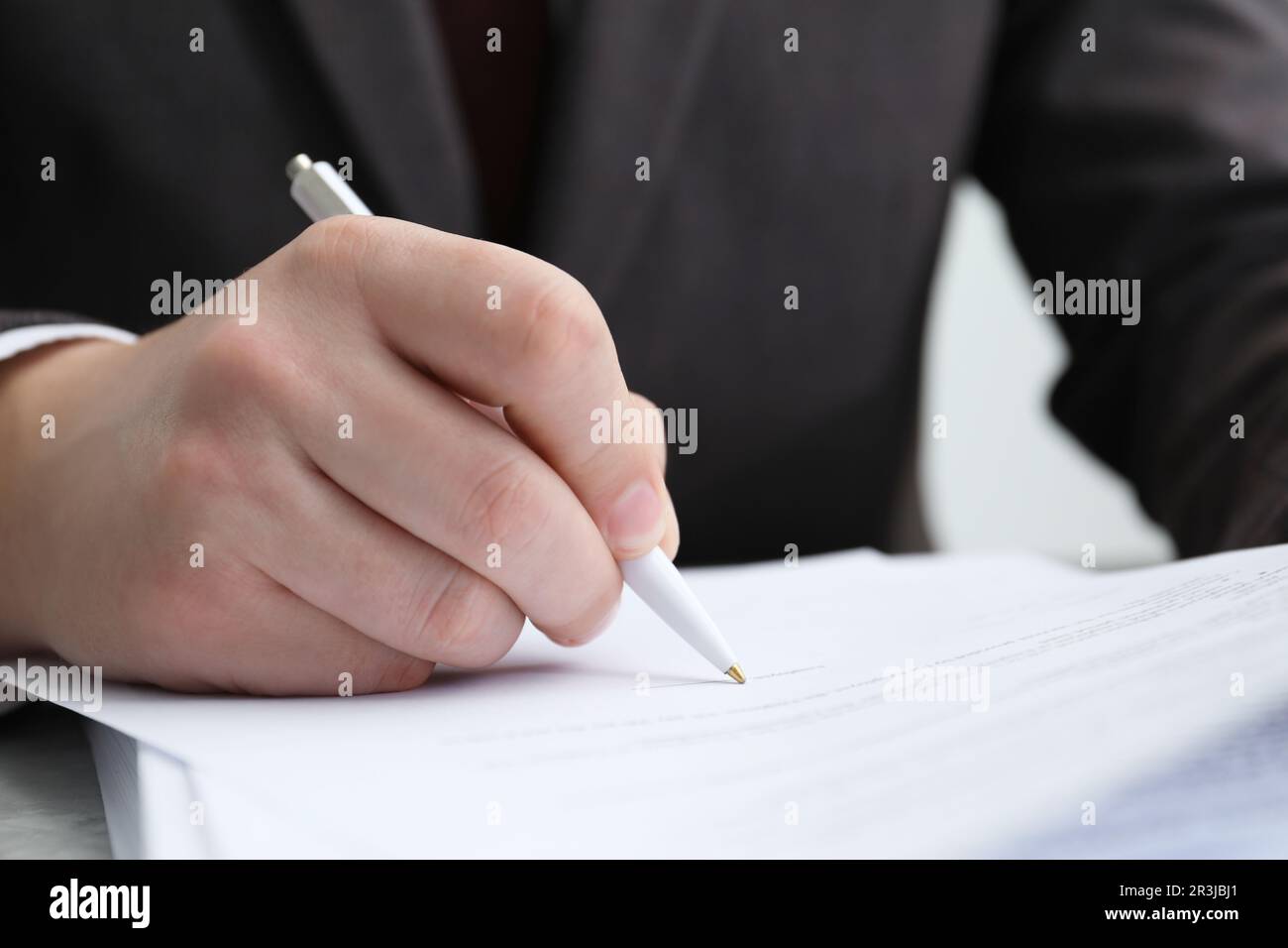 Man signing document at table in office, closeup Stock Photo - Alamy