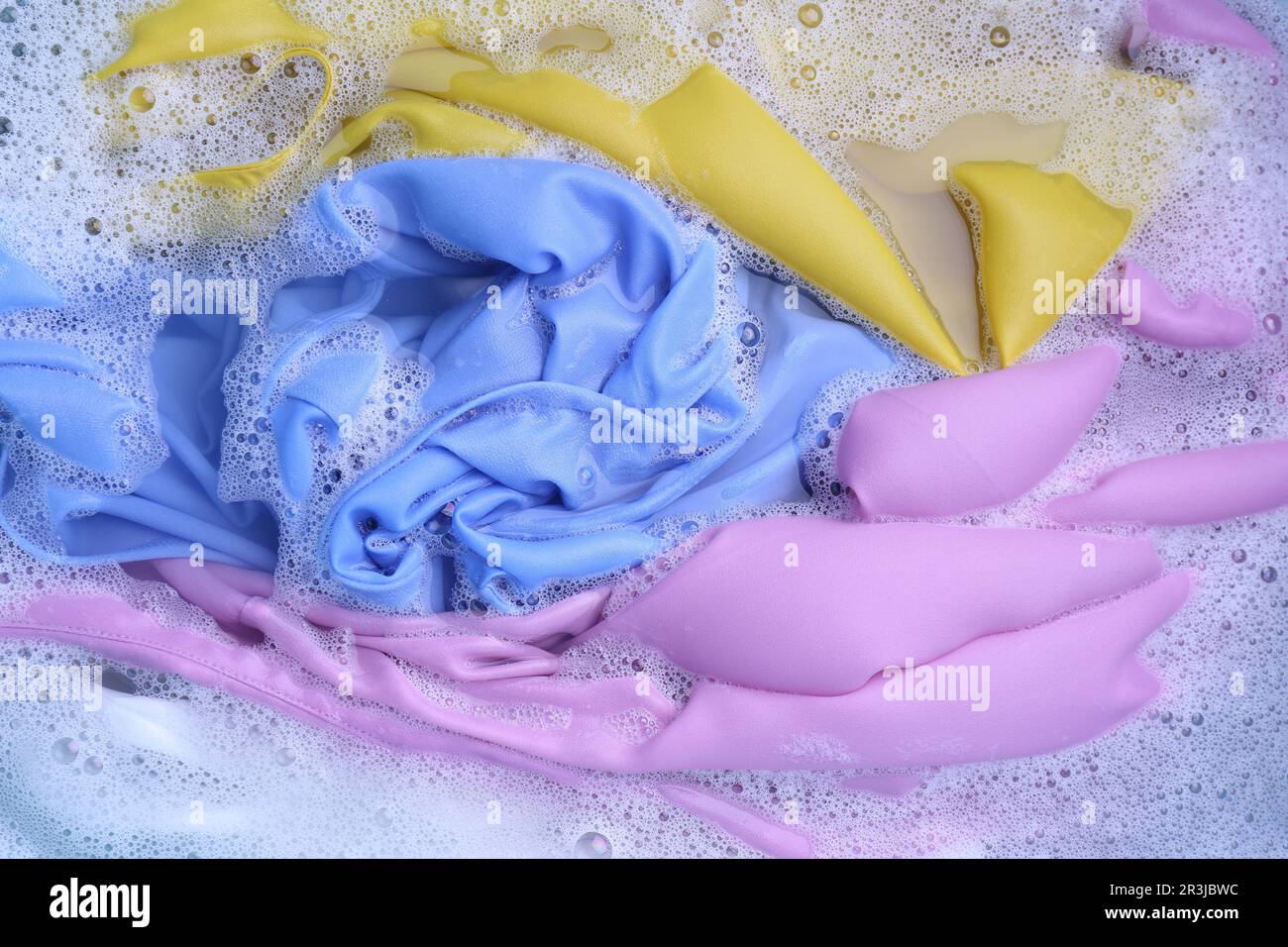 Color clothing in suds, top view. Hand washing laundry Stock Photo - Alamy