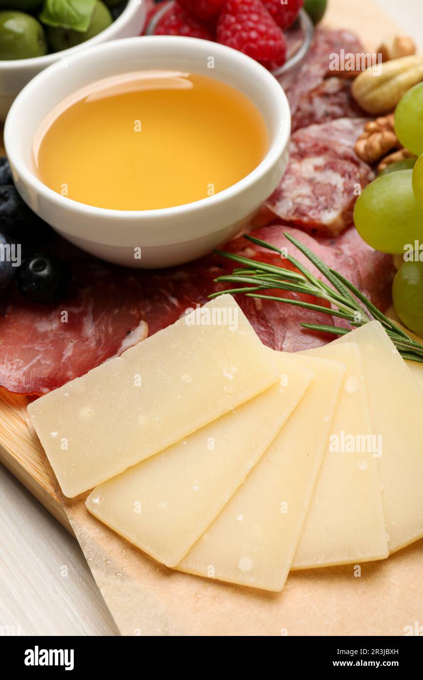 Snack set with delicious Parmesan cheese on board, closeup Stock Photo ...