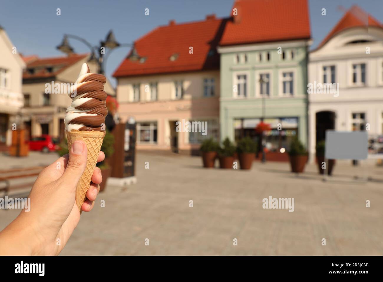 Woman holding delicious ice cream in wafer cone outdoors, closeup ...