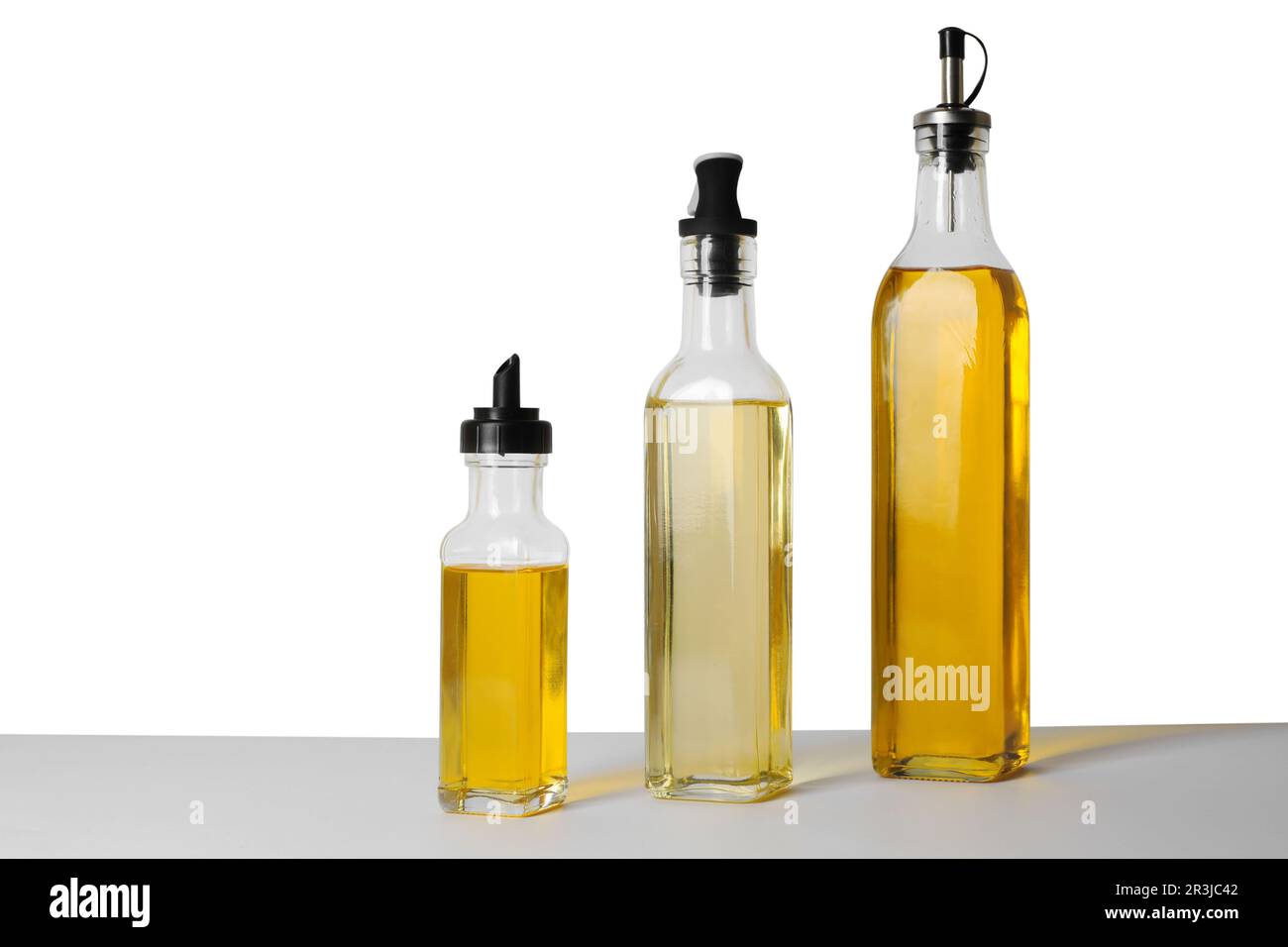 Bottles of different cooking oils on white background Stock Photo - Alamy
