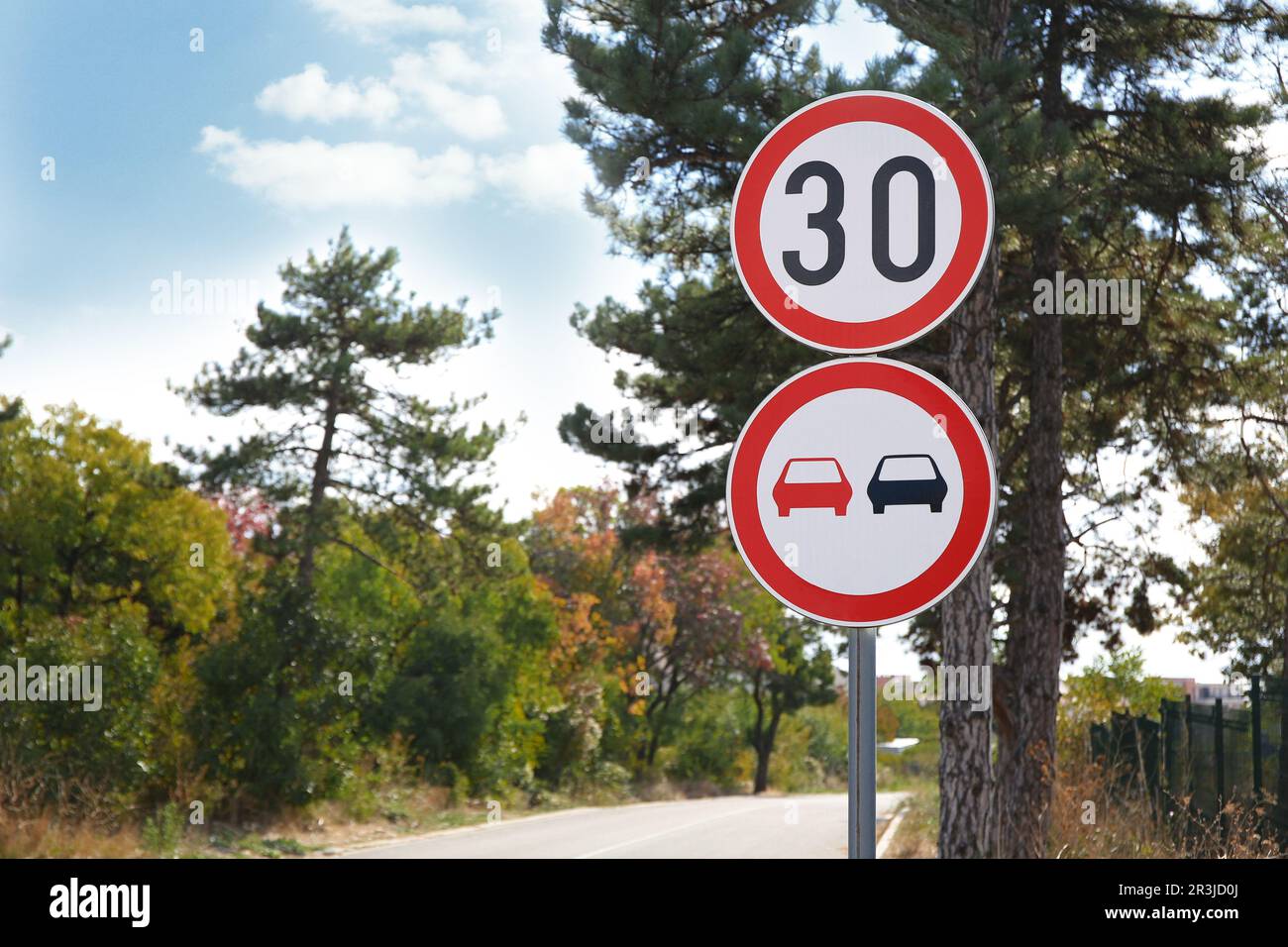 Post with road signs Maximum Speed 30 and No Overtaking outdoors. Space ...