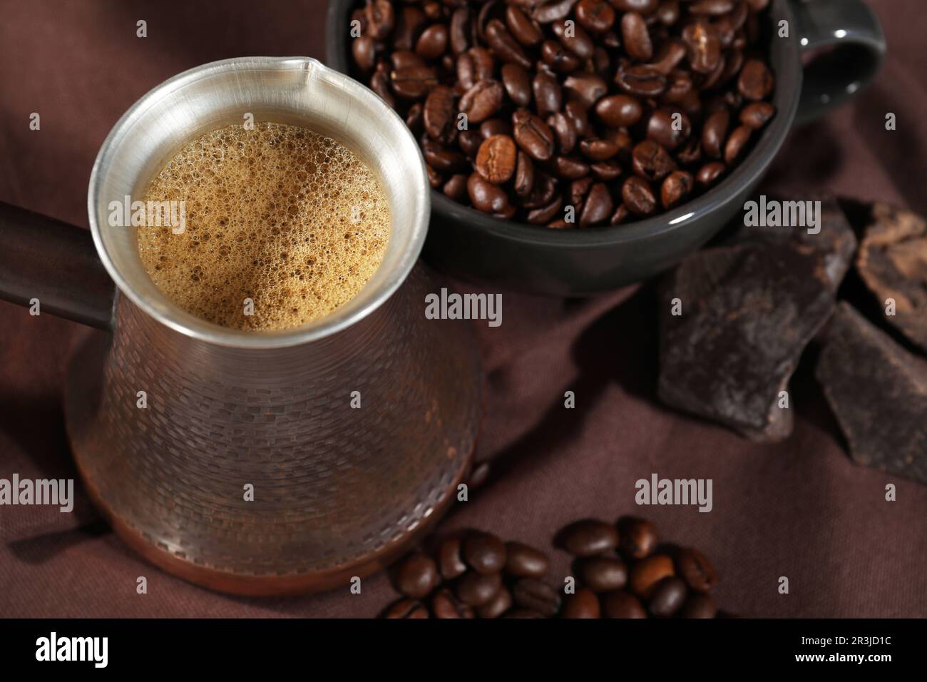 Turkish coffee. Cezve with hot aromatic coffee and beans on table Stock ...