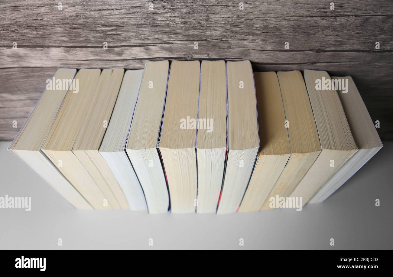 Collection of different books on white shelf, above view Stock Photo ...