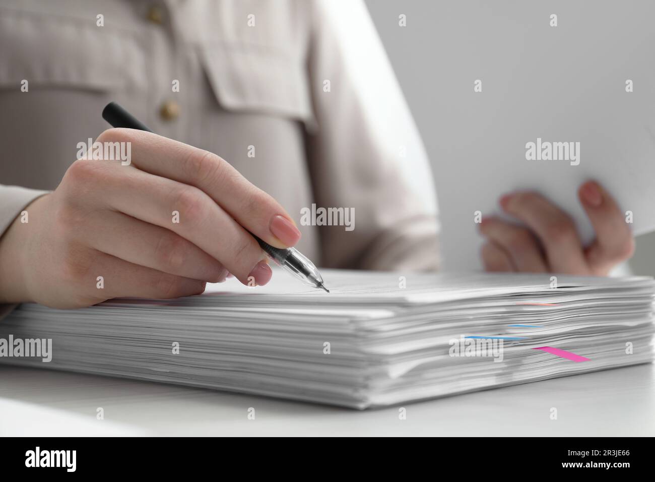 Woman signing documents at wooden table in office, closeup. Space for ...