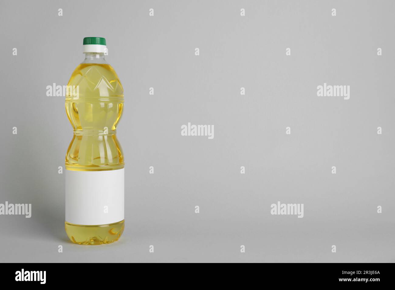Bottle of cooking oil on light grey background. Space for text Stock ...