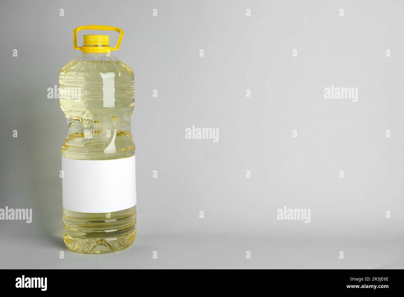 Bottle of cooking oil on light grey background. Space for text Stock ...