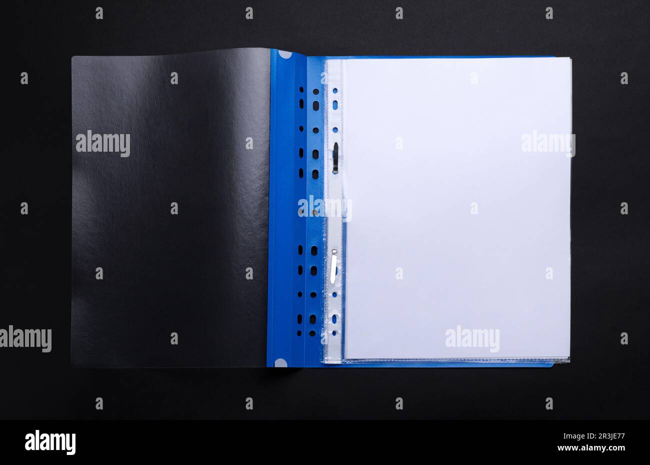 File folder with punched pockets and paper sheets on black background ...